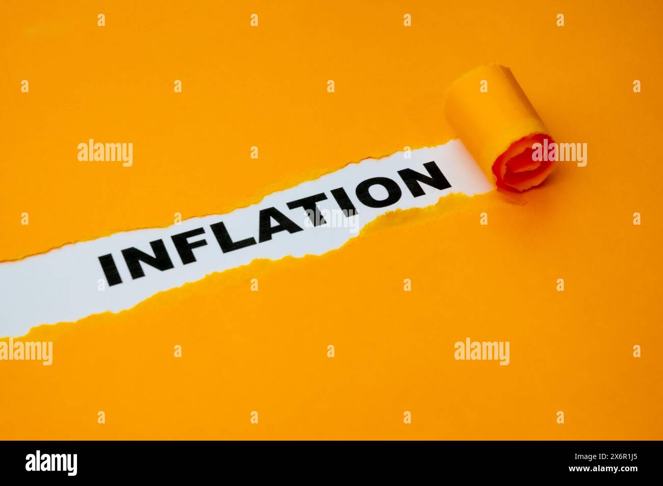 White surface, with the word Inflation in black, underneath torn and ...