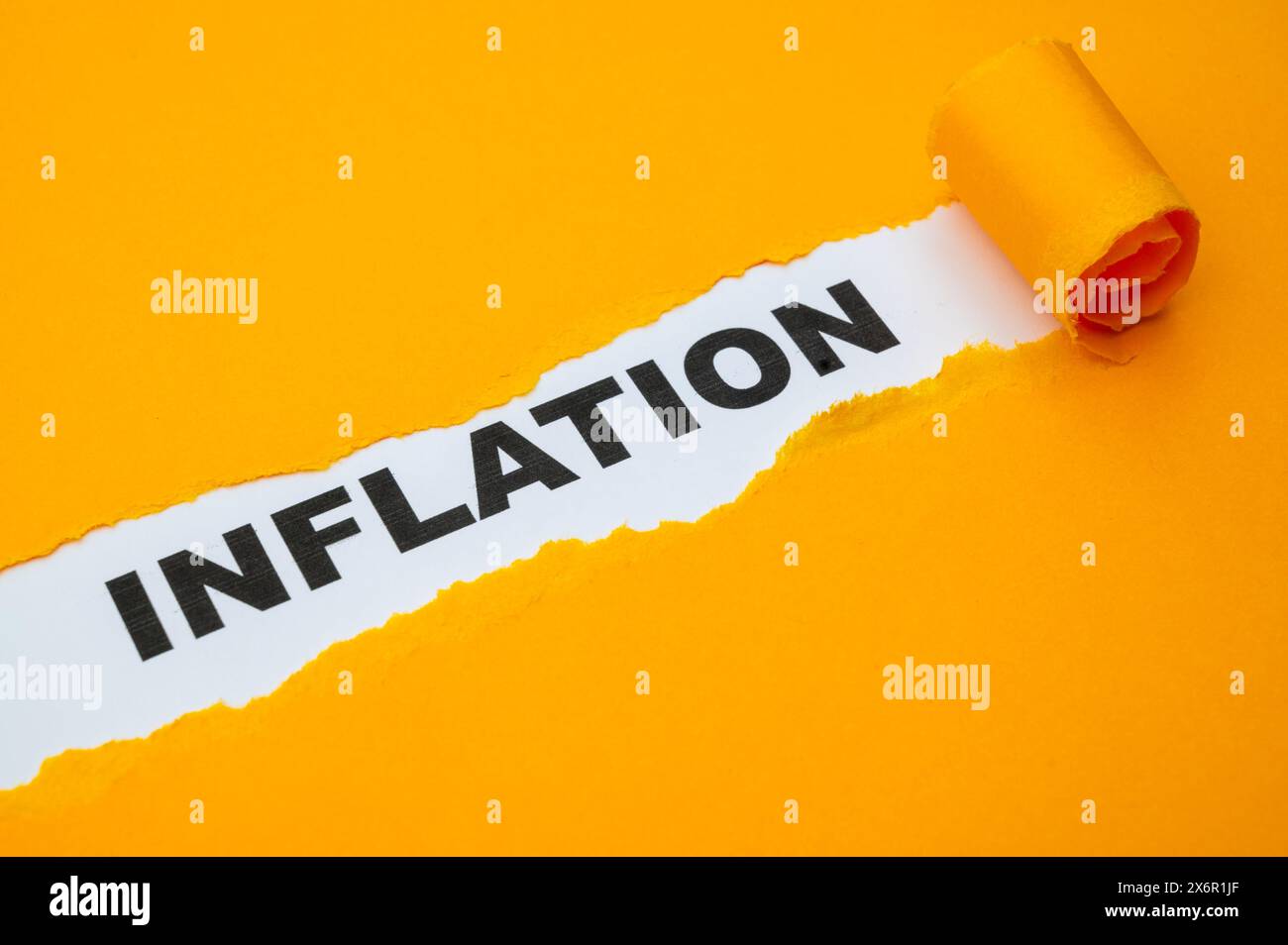 White surface, with the word Inflation in black, underneath torn and ...