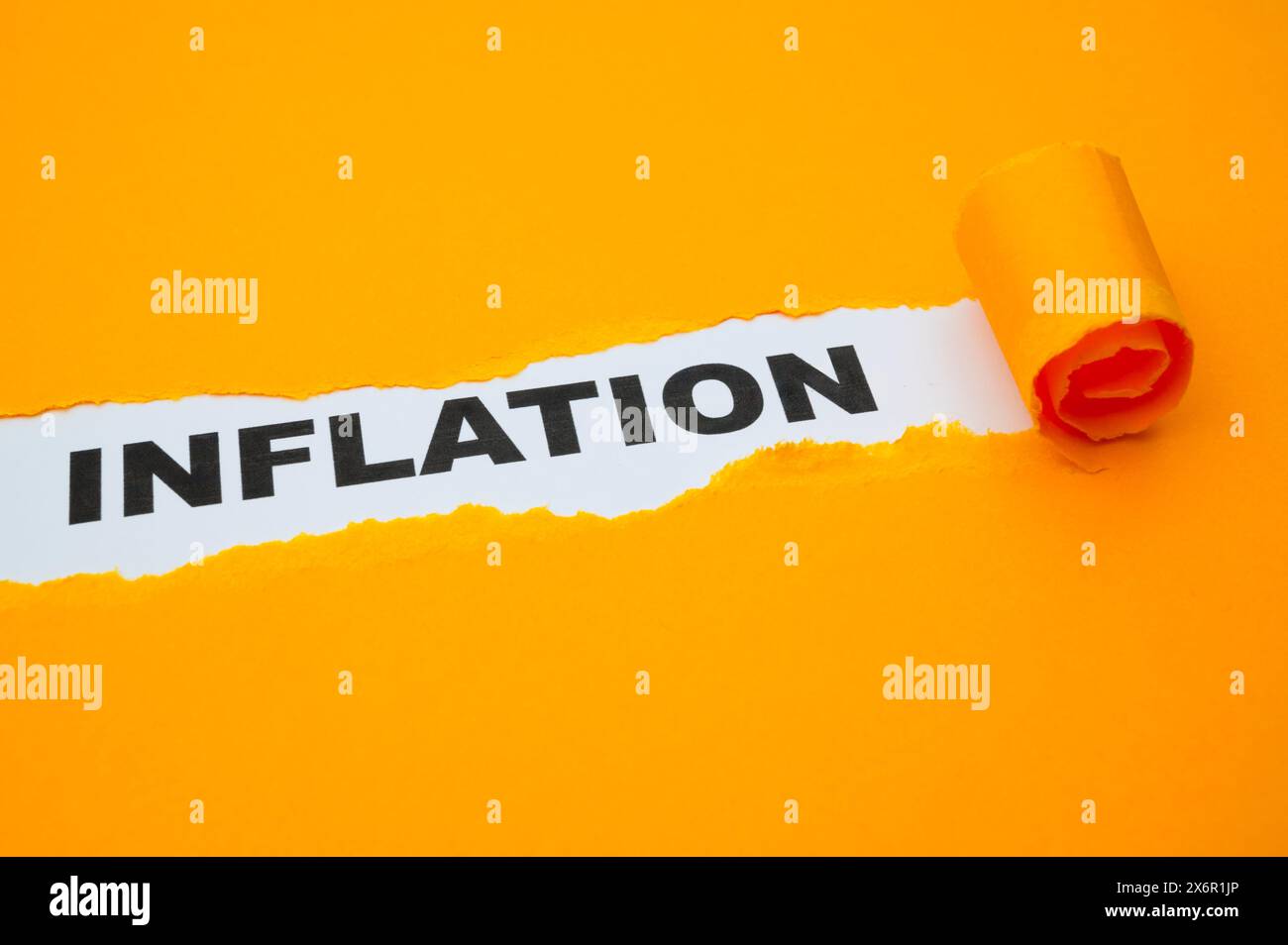 White surface, with the word Inflation in black, underneath torn and ...