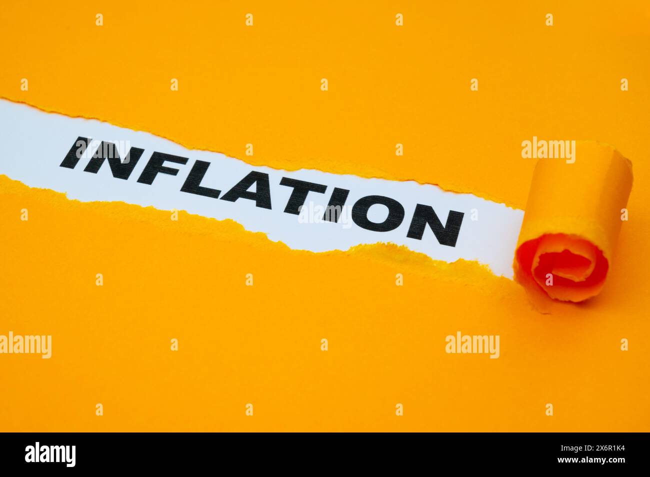 White surface, with the word Inflation in black, underneath torn and ...