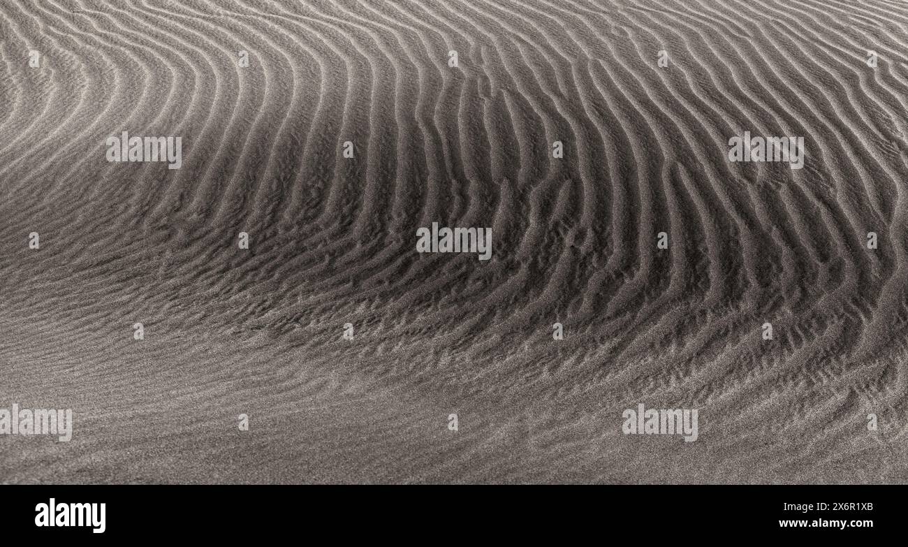 natural sand pattern created by wind blowing differently sized and ...