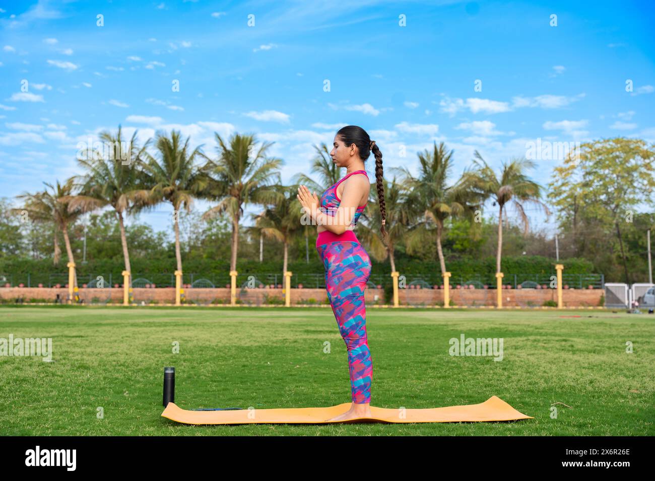 Young fit indian girl doing namaskar yoga pose in her garden. exercise ...