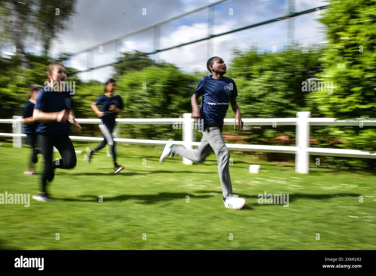 Children participate in a running race of 2,024 m on the track at the ...