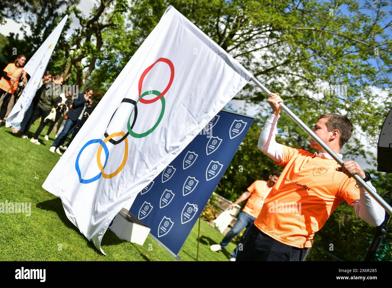 A participant holds the Olympic Games flag as French sprinter and ...