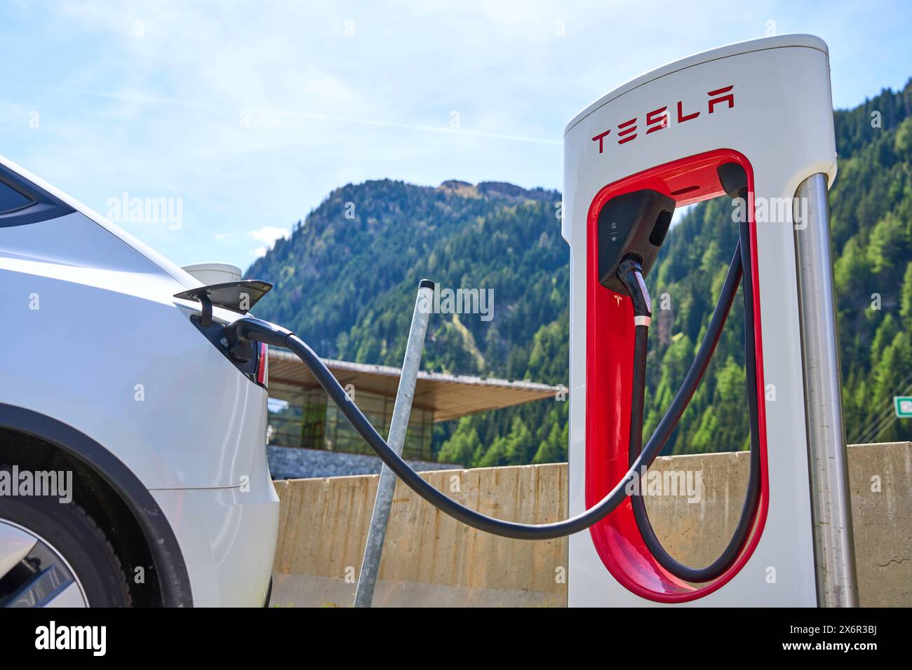 Brenner, Italy - May 11, 2024: Tesla e-car charges electricity at a ...