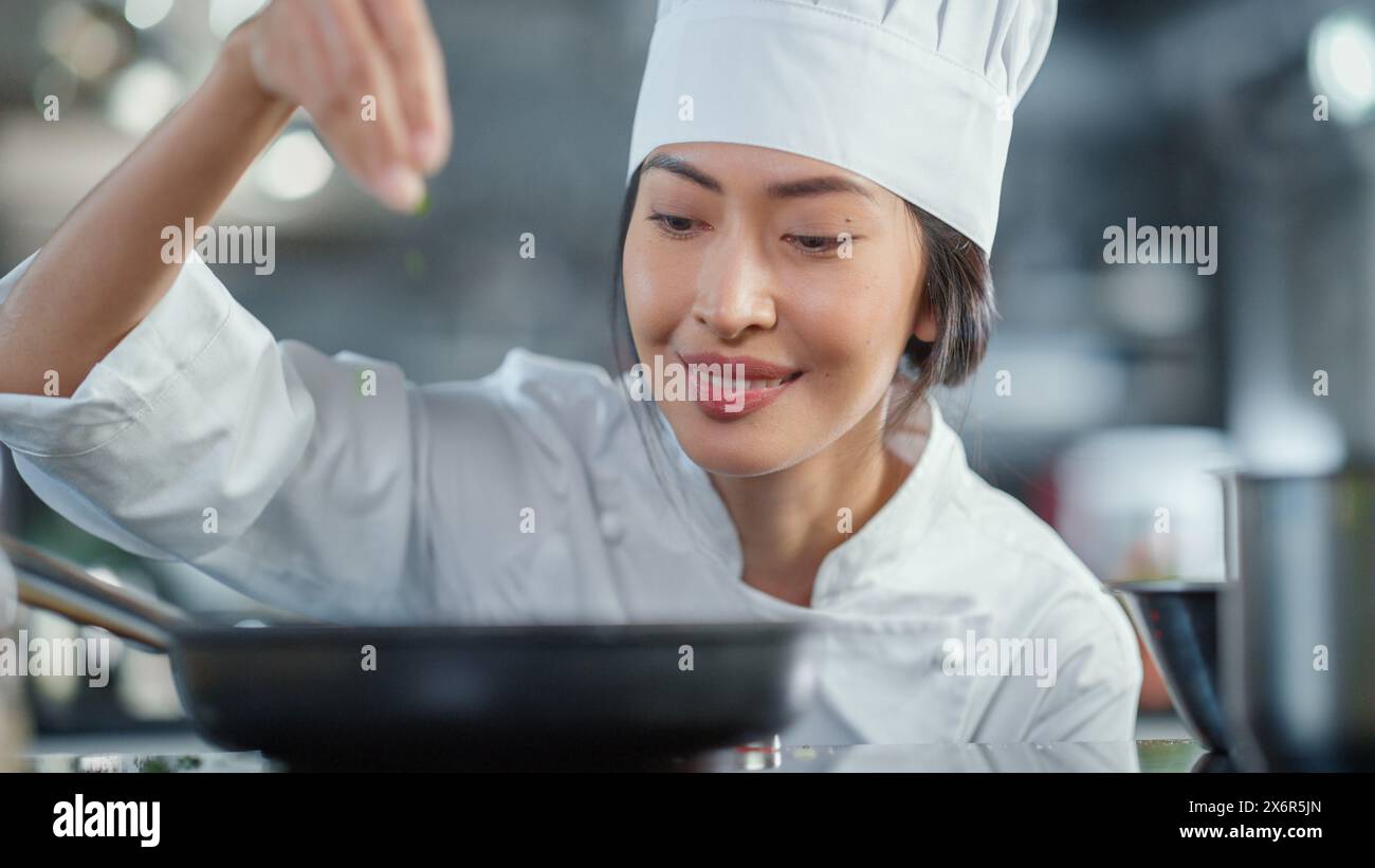 Restaurant Kitchen: Portrait of Asian Female Chef Fries Uses Pan ...