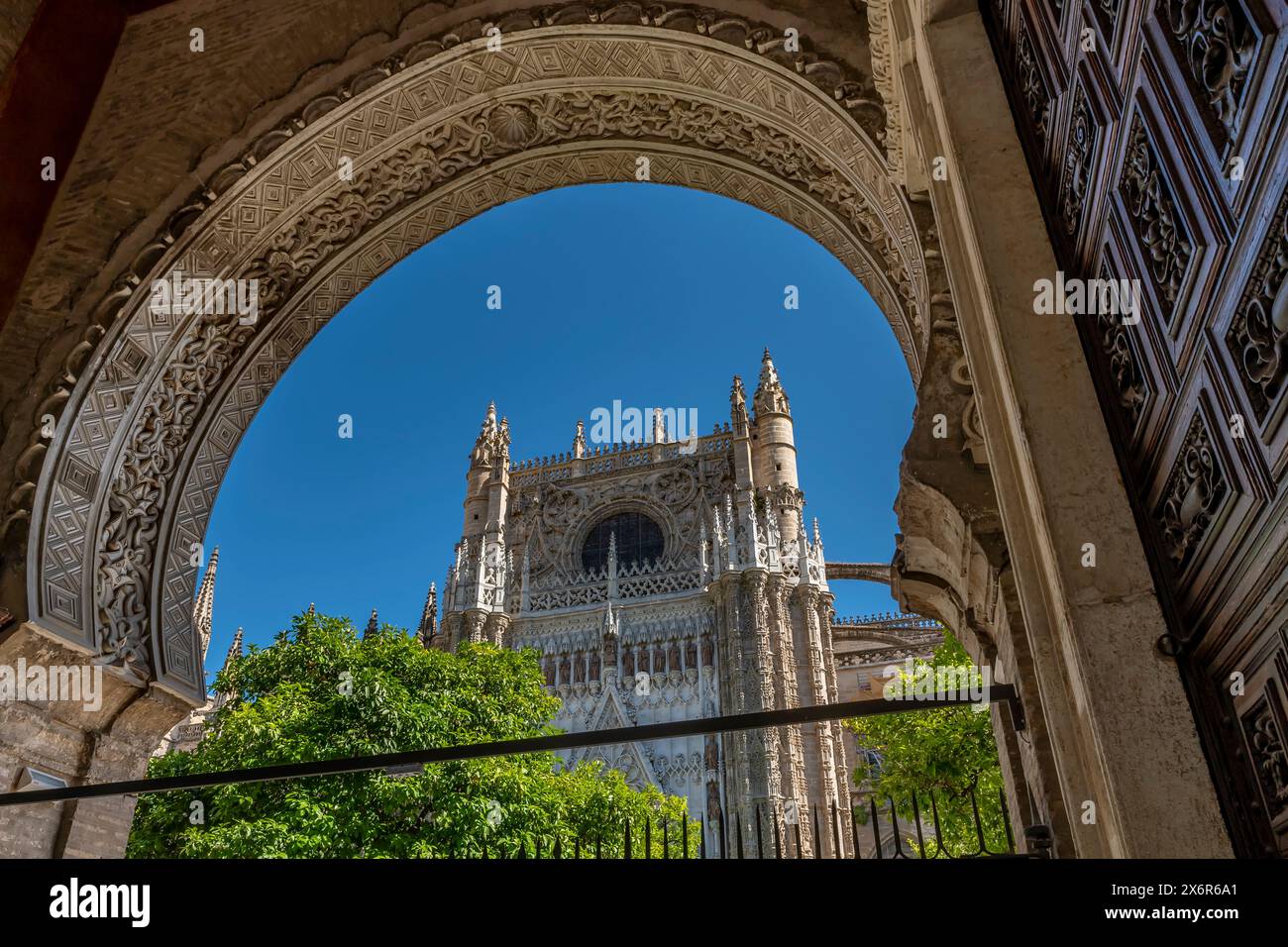 The cathedral of Seville, Spain framed by an Arabic style arch Stock ...