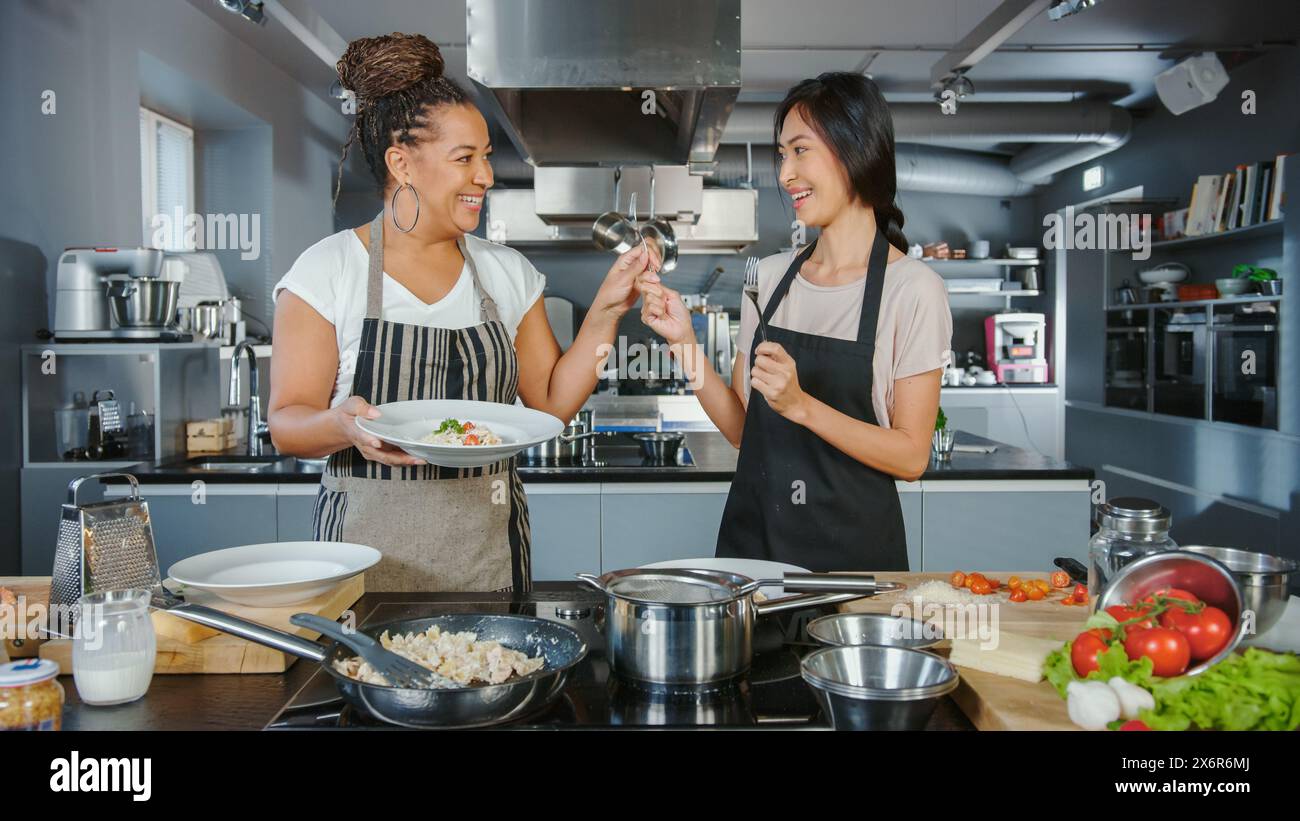 TV Cooking Show Kitchen with Two Master Chefs. Asian and Black Female ...