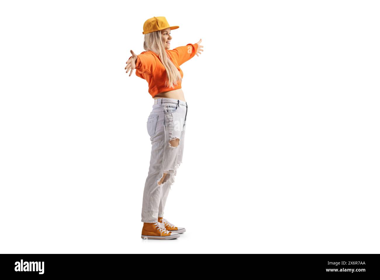 Full length profile shot of a young female waiting with arms open ...