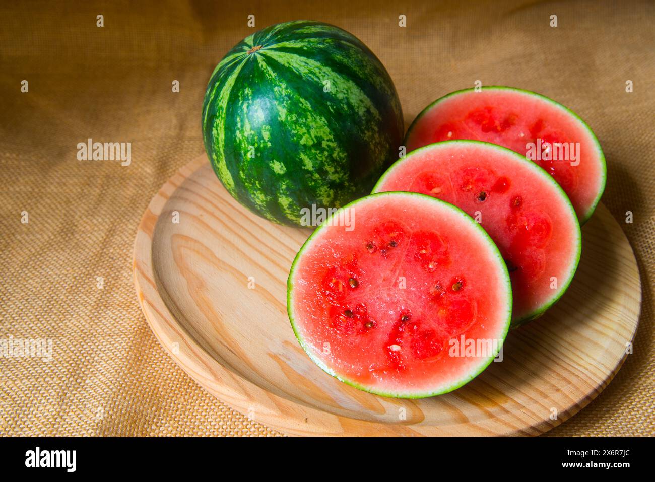 Two watermelons, one of them cut in slices. Still life Stock Photo - Alamy