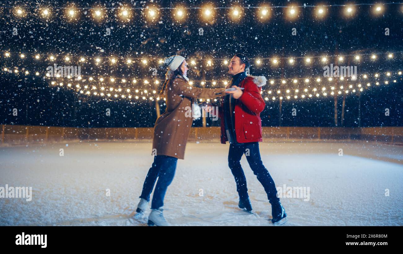Romantic Winter Snowy Evening: Ice Skating Couple Having Fun on Ice ...
