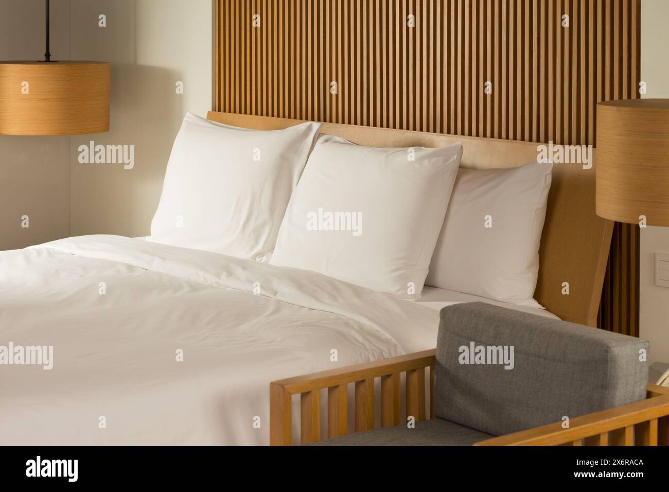 A modern and elegant bedroom showcasing a well-made bed with clean ...