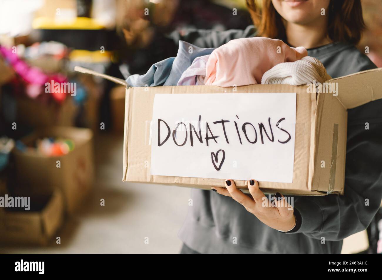 Volunteer teengirl preparing donation boxes for people Stock Photo - Alamy