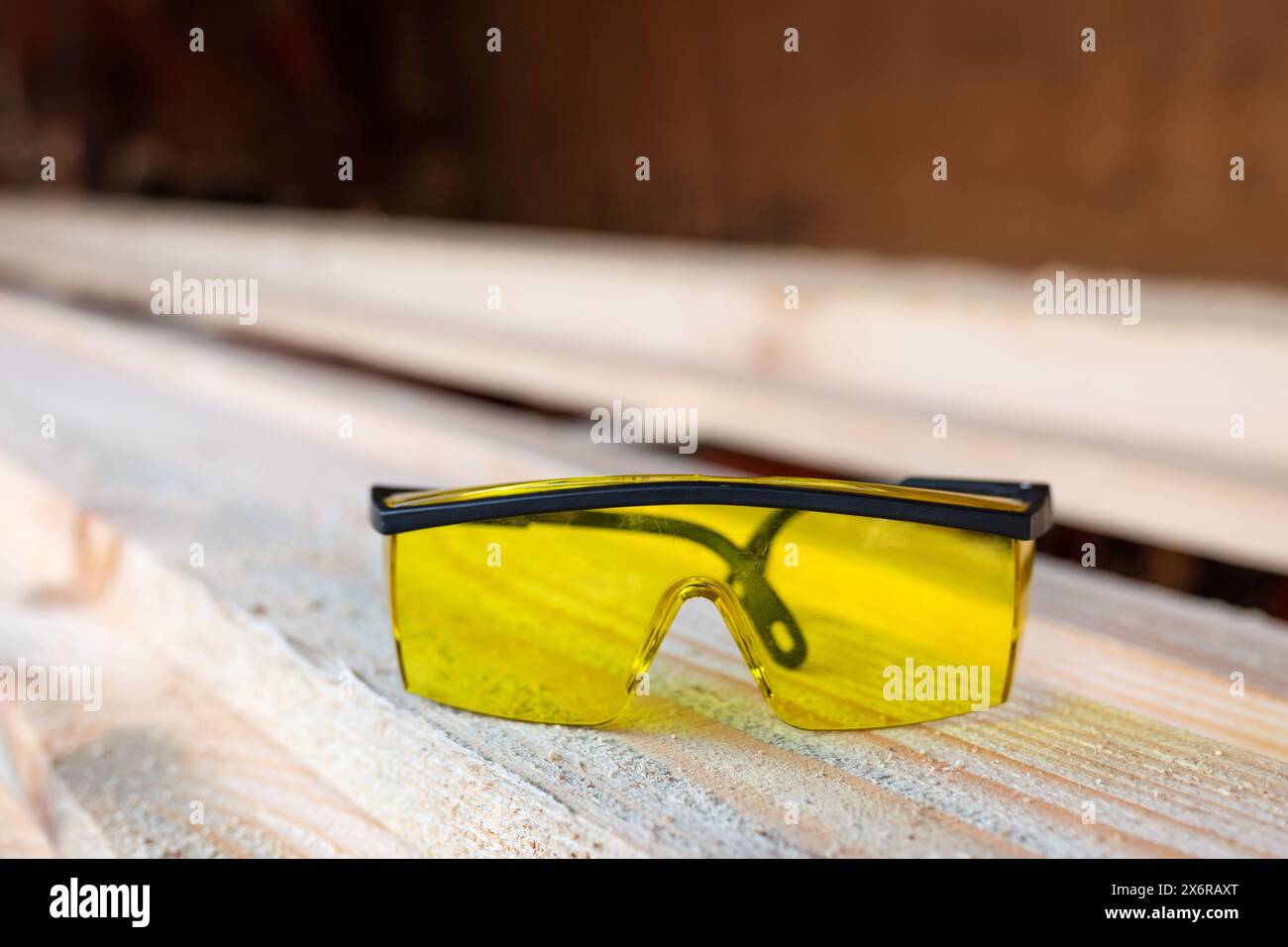 Sawmill. Construction safety goggles on wood planks of sawmill ...