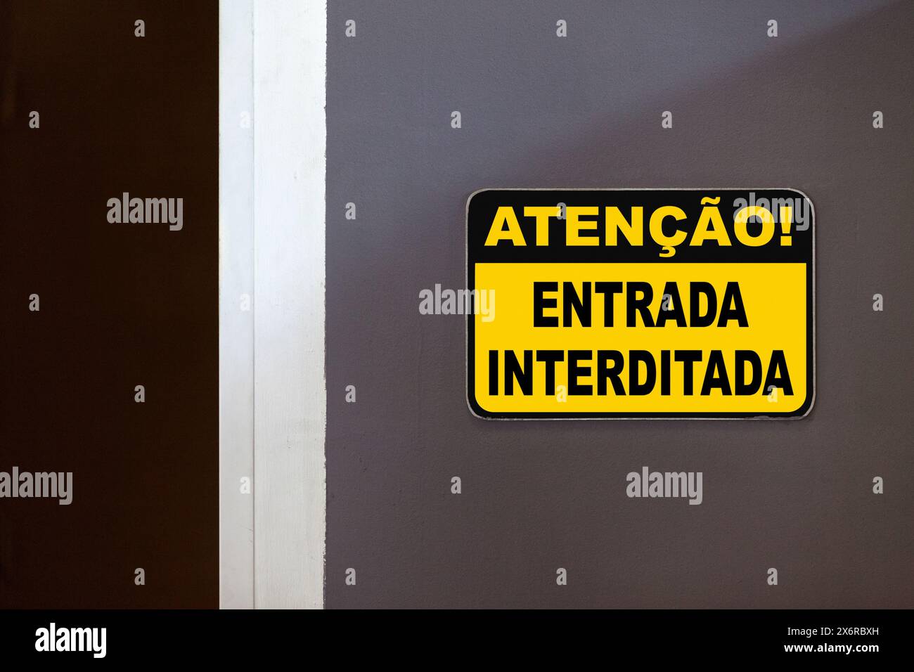 Yellow and black warning sign on the side of an open door stating in ...