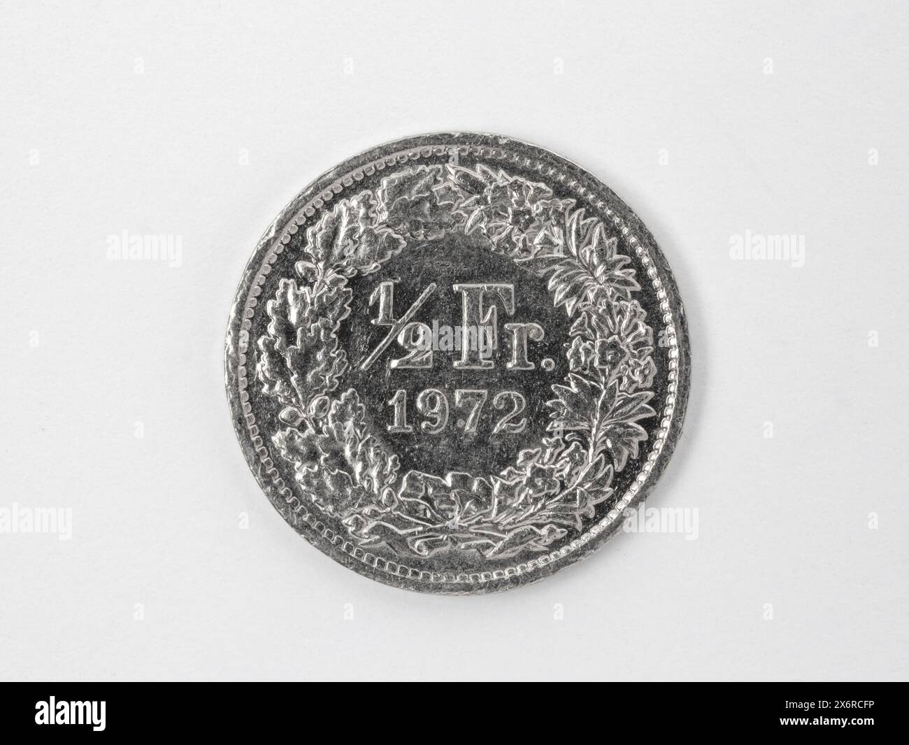 Close-up of a swiss one half franc coin, white background, front side ...