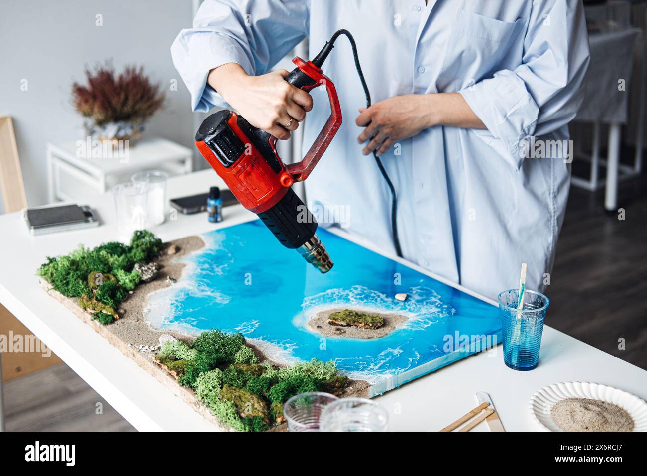 Artist Using Heat Gun on Epoxy Resin Coastal Artwork Stock Photo - Alamy