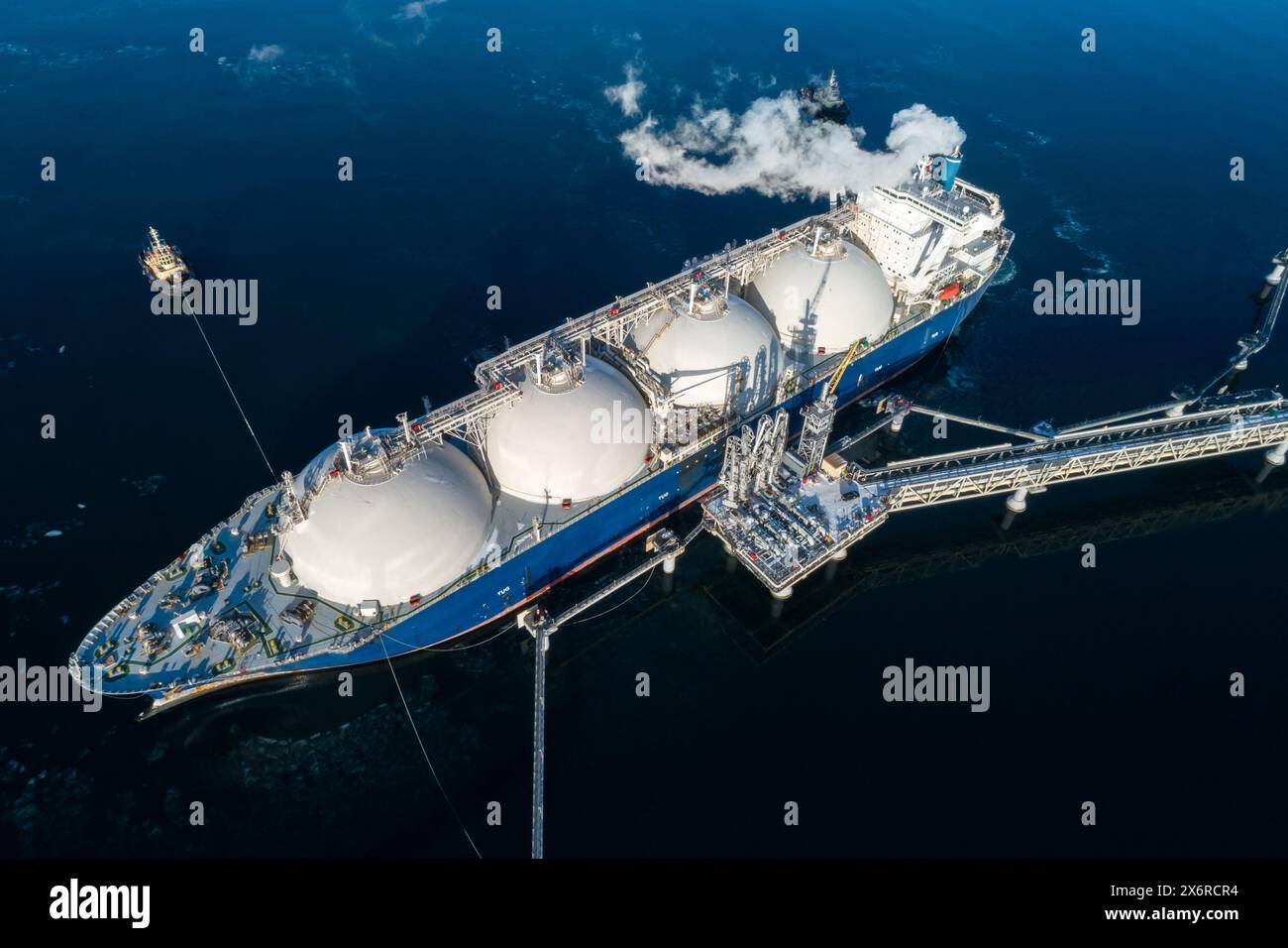 Large lng tanker docked at industrial port terminal for cargo ...