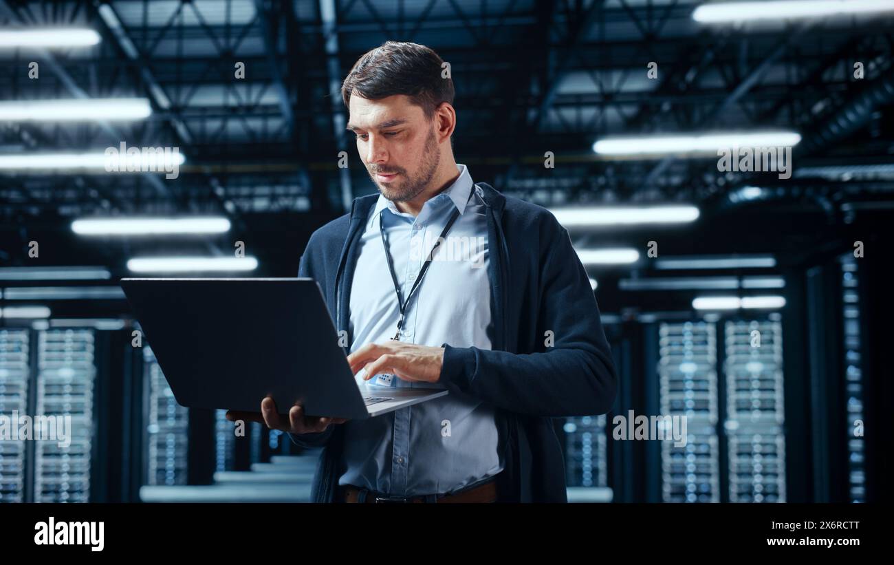 Successful Data Center IT Specialist Using Laptop Computer. Server Farm ...