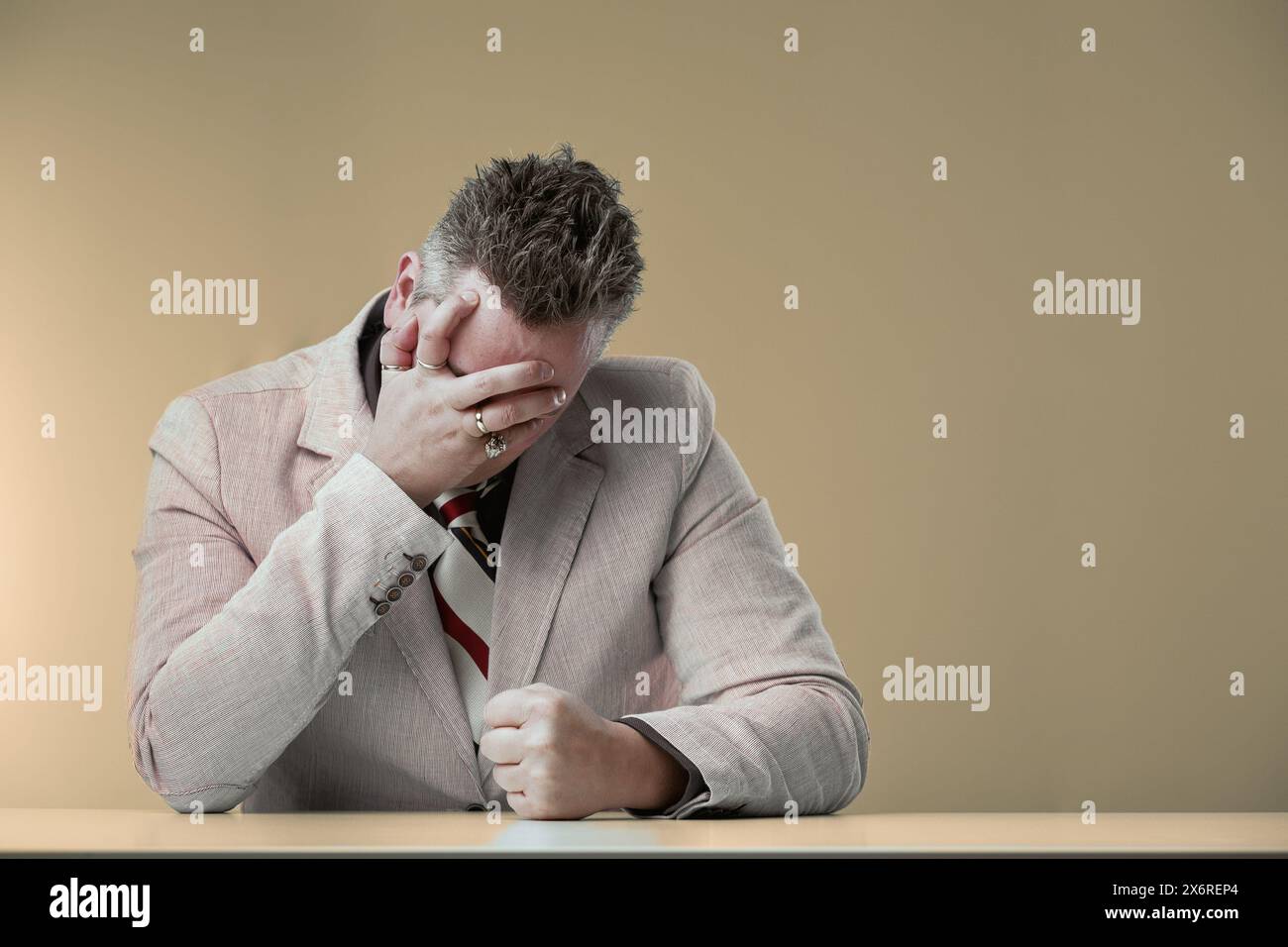 Overwhelmed with stress, a professional man struggles to cope, his ...