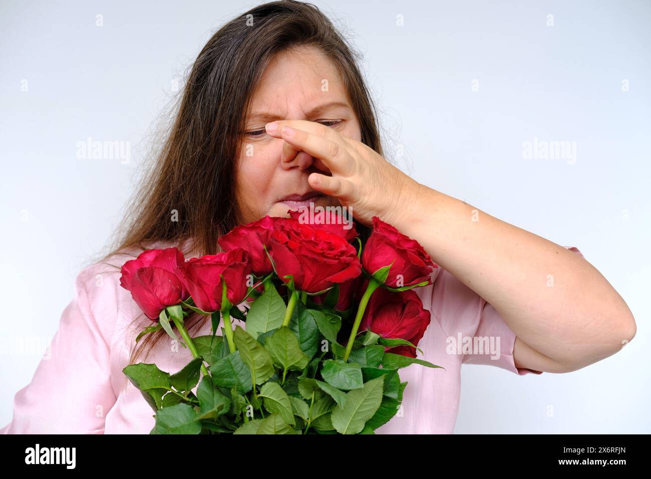 bouquet of flowers, red roses, middle-aged woman 50 years old with ...