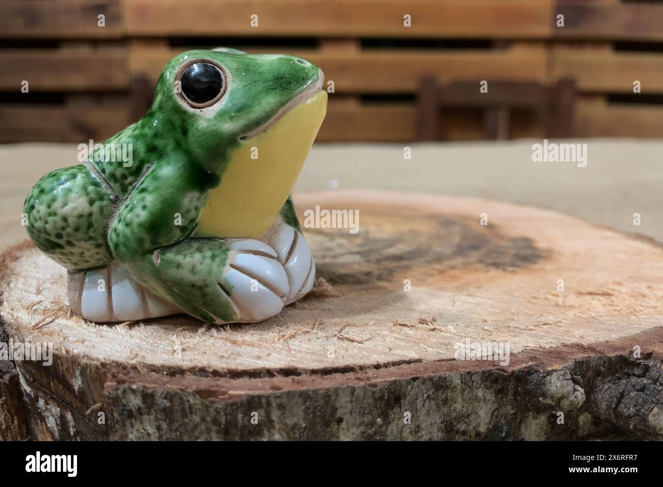 Green frog on the wood. Fake frog Stock Photo - Alamy