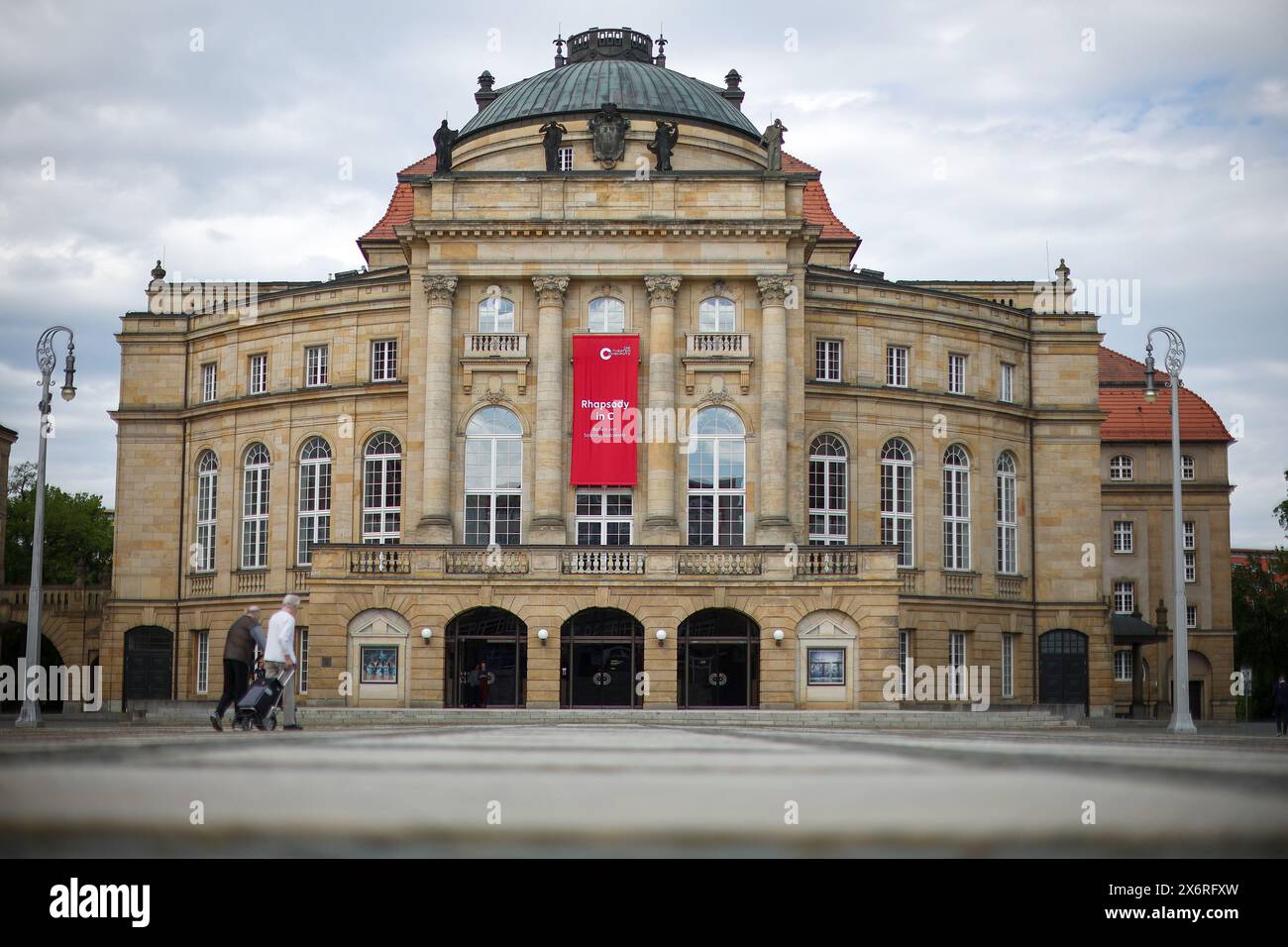 Chemnitz, Germany. 16th May, 2024. Passers-by walk across Theaterplatz ...