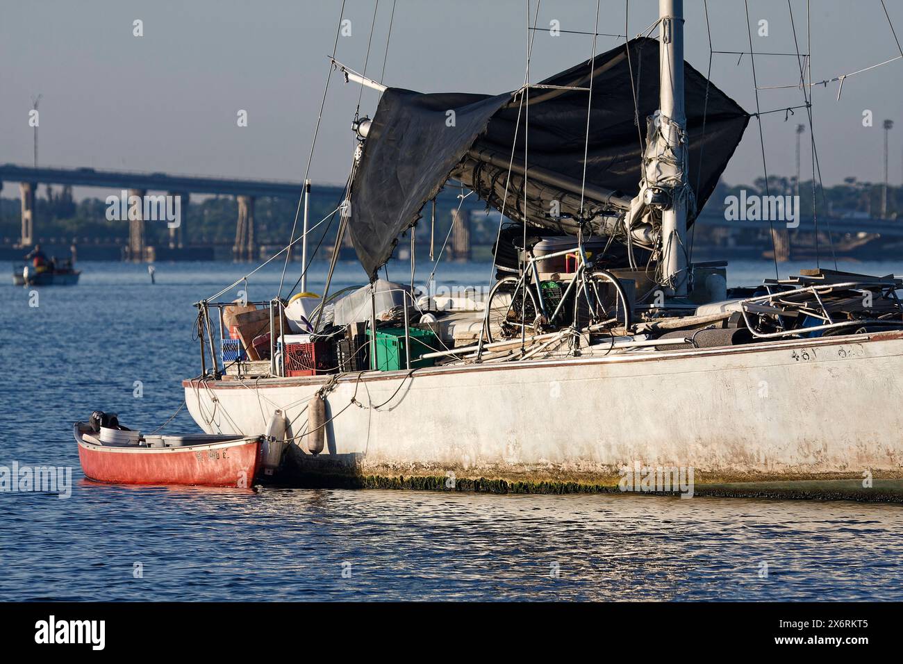 old sailboat, anchored, deck and cockpit filled with things, marine ...