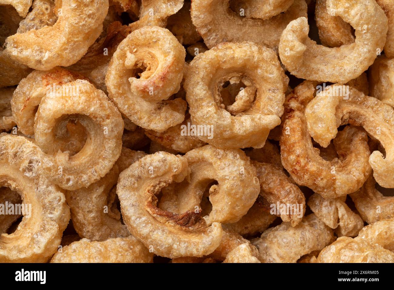 Traditional fried salted pork rind full frame as background close up ...
