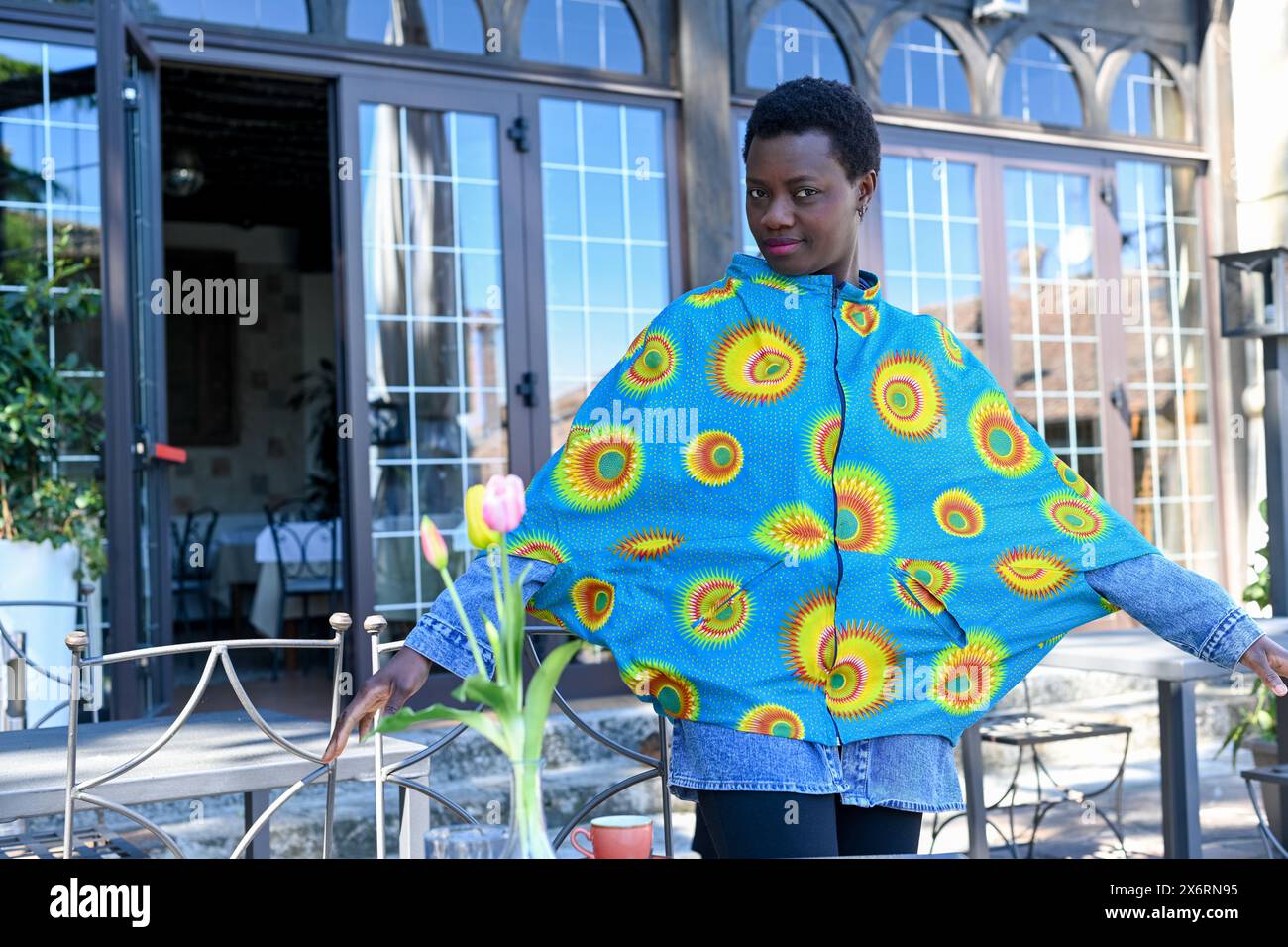Fashionable african woman wearing a vibrant poncho, striking a pose ...