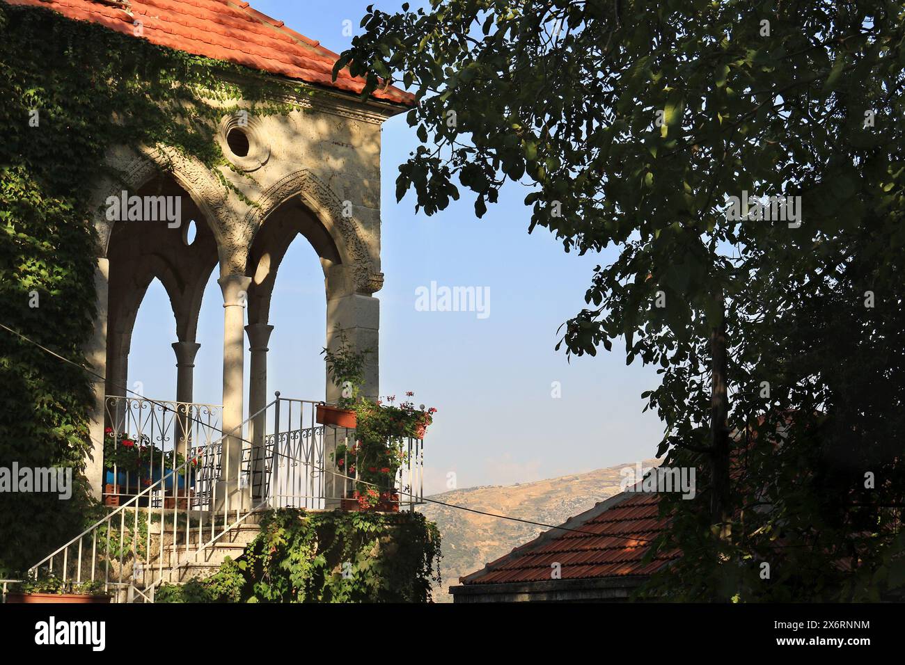 A traditional Lebanese house with arches from behind trees Stock Photo ...