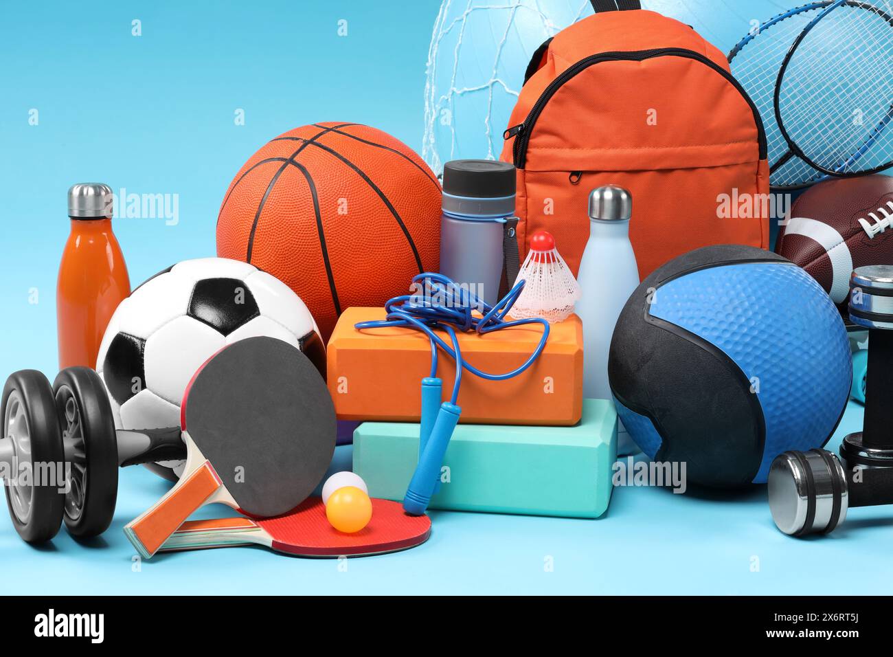 Many different sports equipment on light blue background, closeup Stock ...