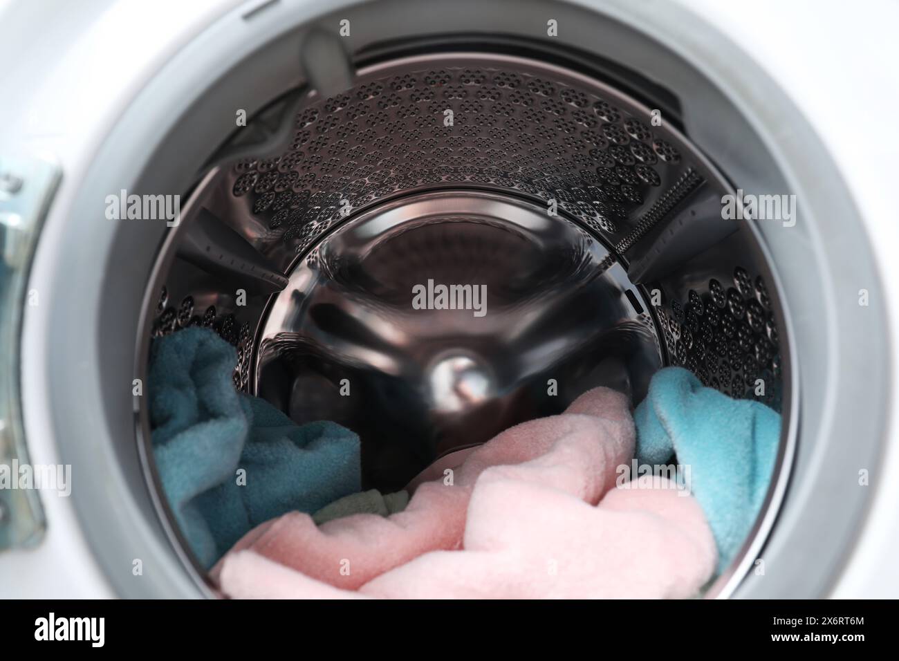 Modern washing machine drum with laundry, closeup Stock Photo - Alamy