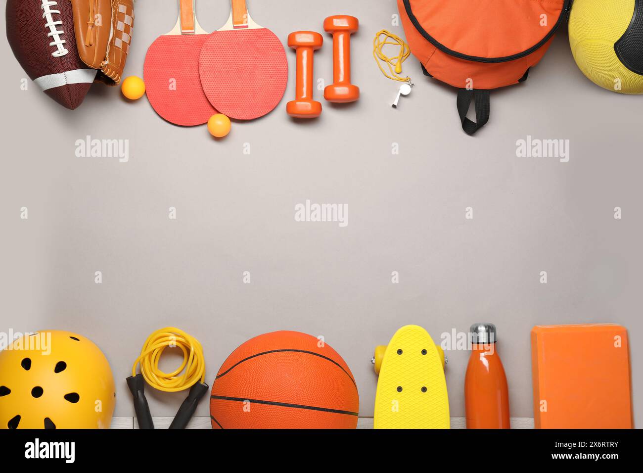 Frame made of different sports equipment on light grey background, flat ...