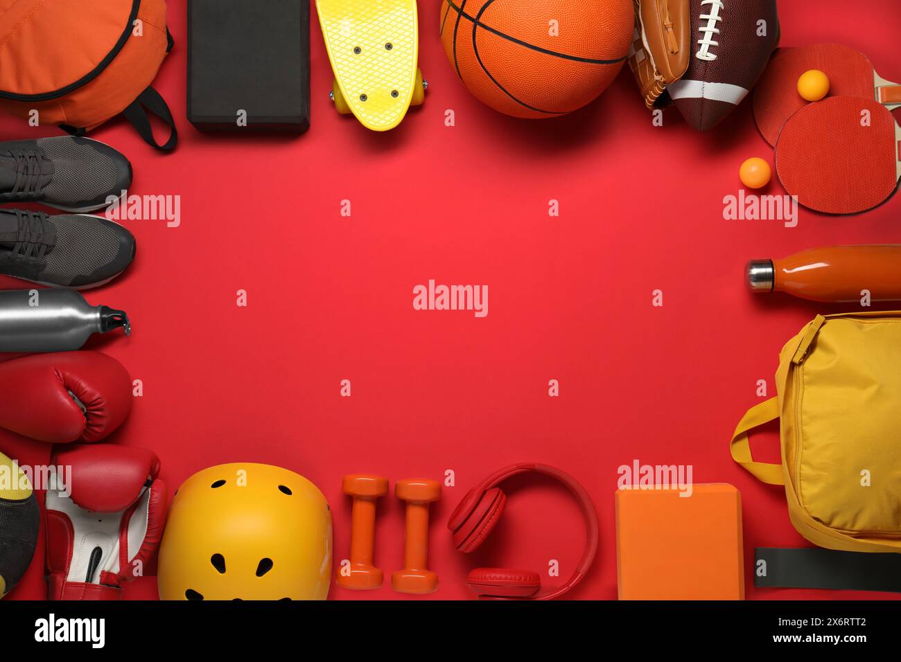 Frame made of different sports equipment on red background, flat lay ...