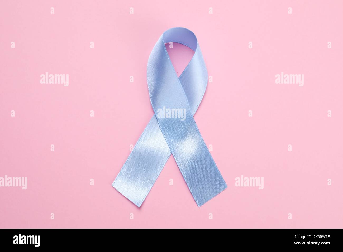 International Psoriasis Day. Ribbon as symbol of support on pink ...