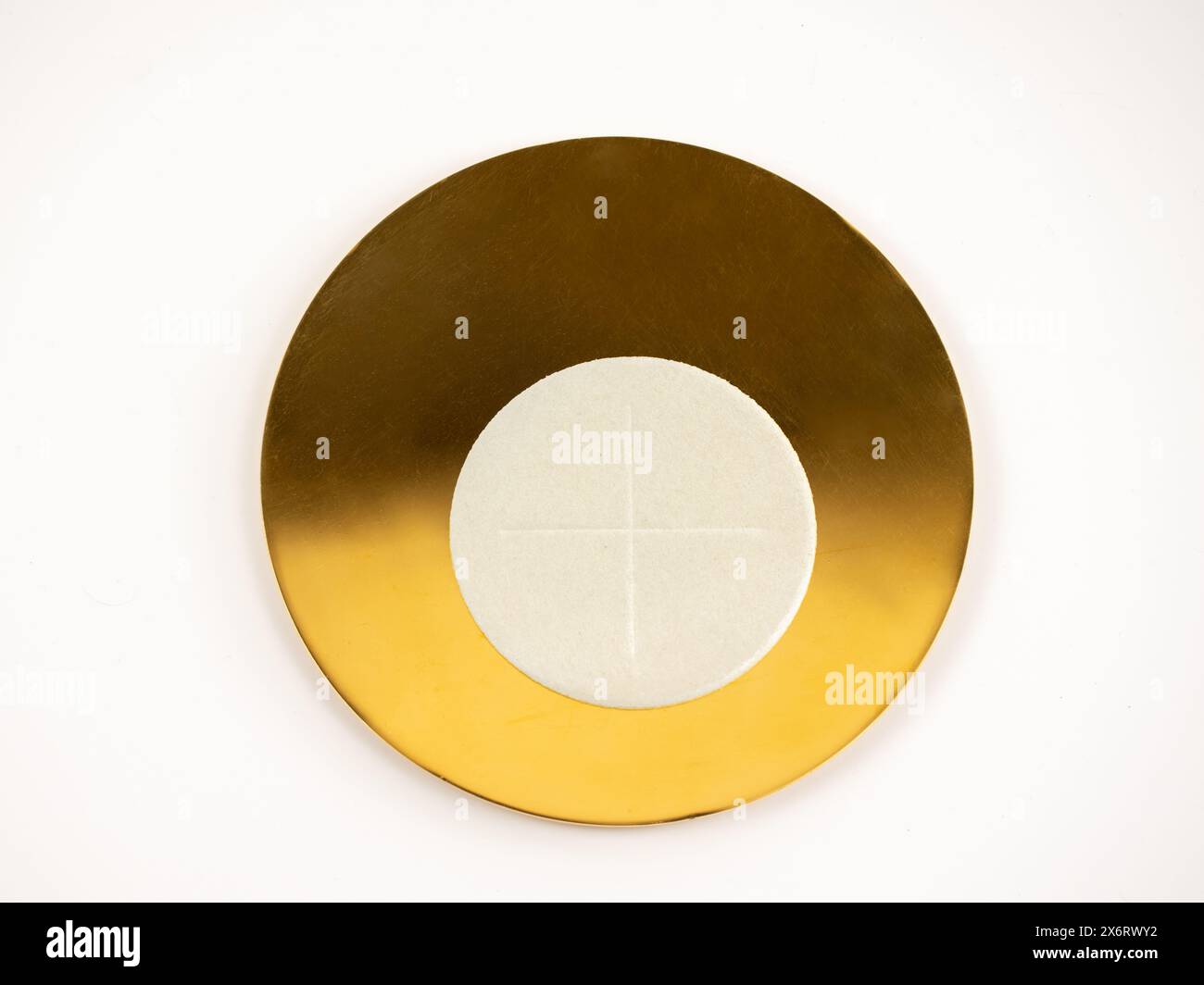 Gilded paten with white altar bread - holy bread, white background ...