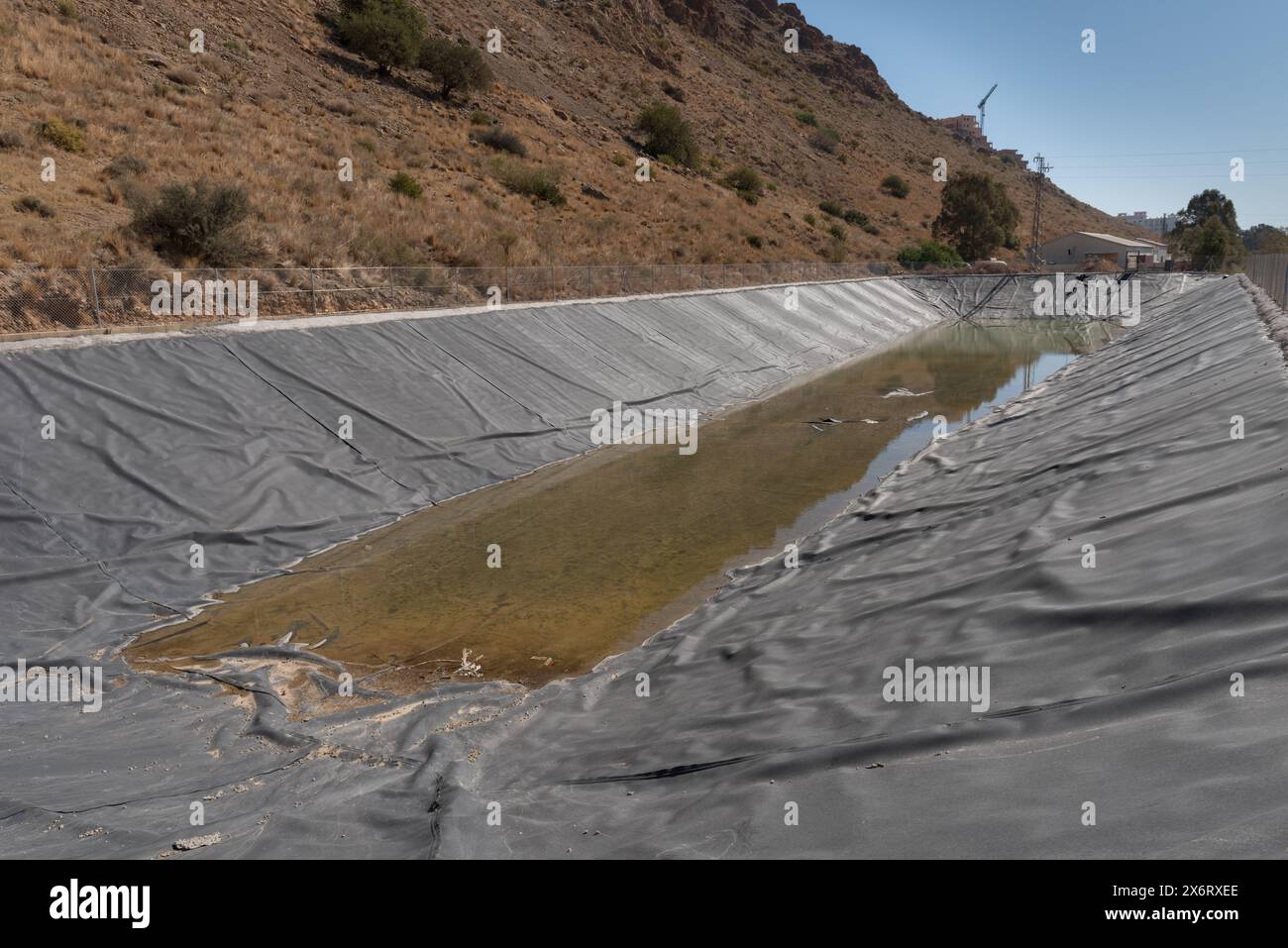 Empty irrigation lined pond, water reservoir in Spain, lack of rain a ...