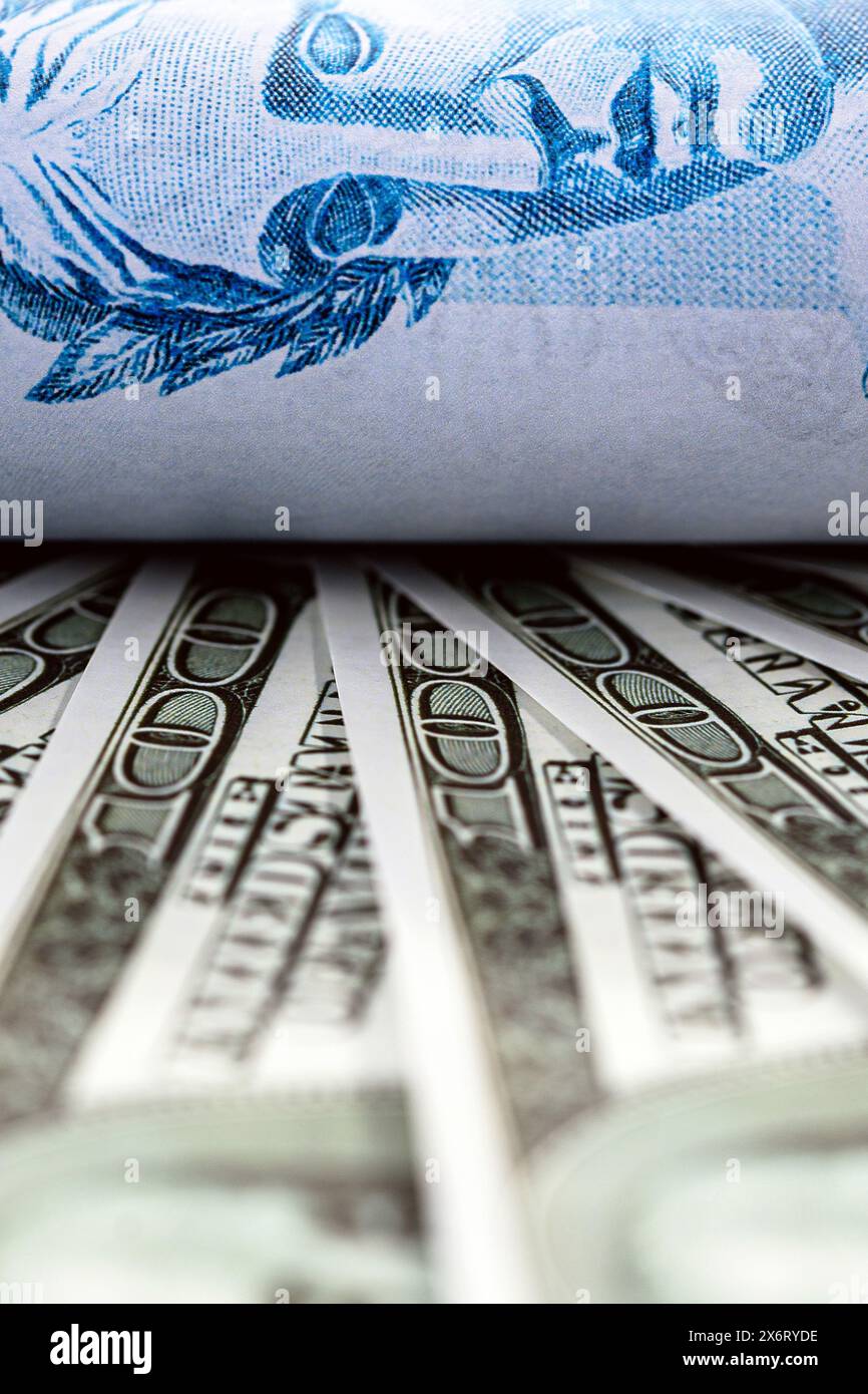 american money surrounding a hundred reais banknote from brazil ...