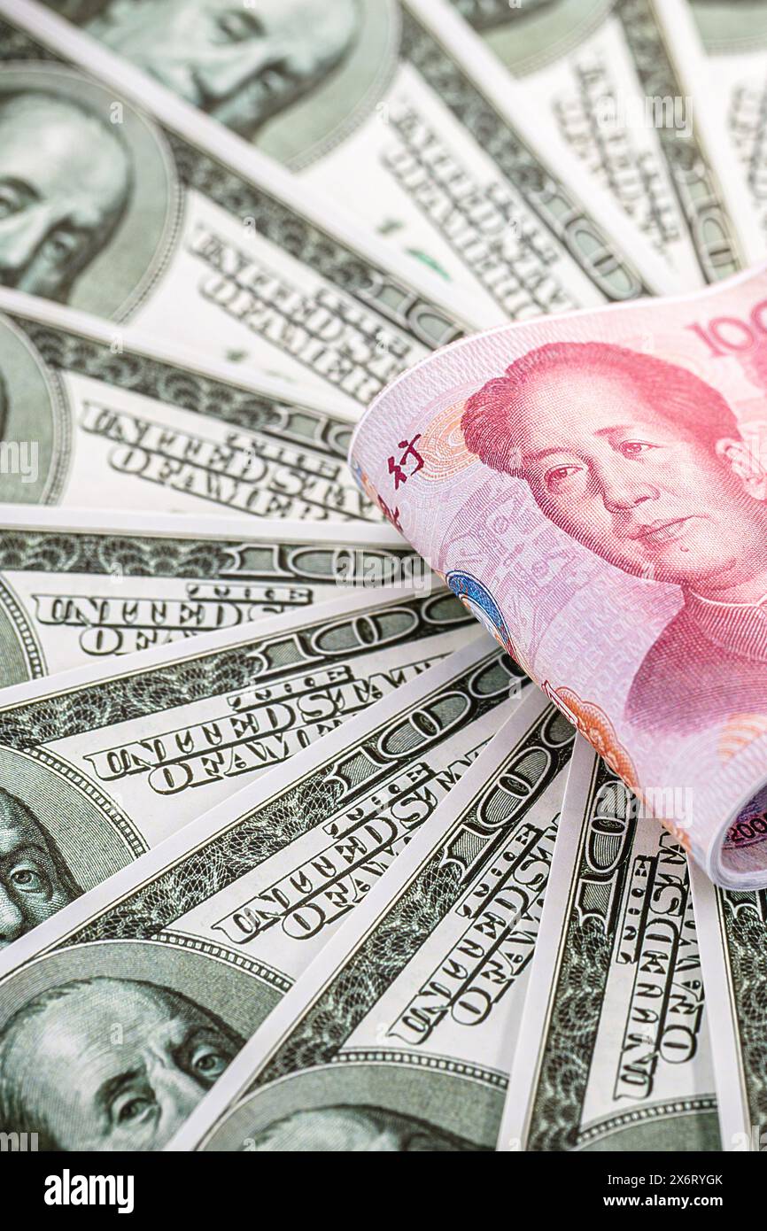 100 dollar banknotes with one hundred yuan banknote (Renminbi), concept ...