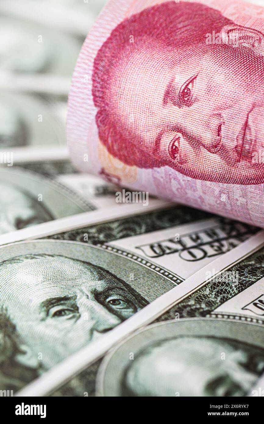 100 dollar banknotes with a hundred yuan note (Renminbi), concept of ...