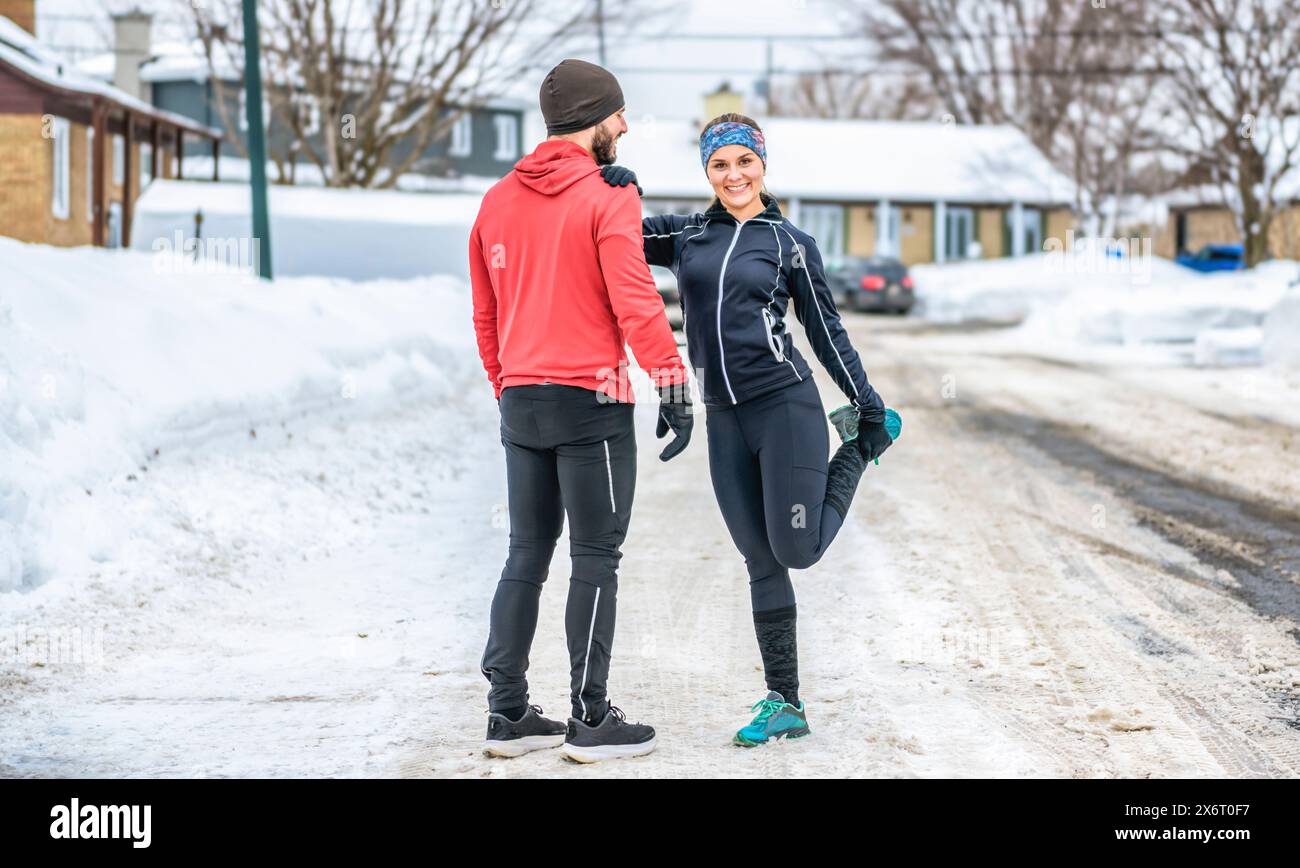 Nice active runner couple jogging together neighborhood Stock Photo - Alamy