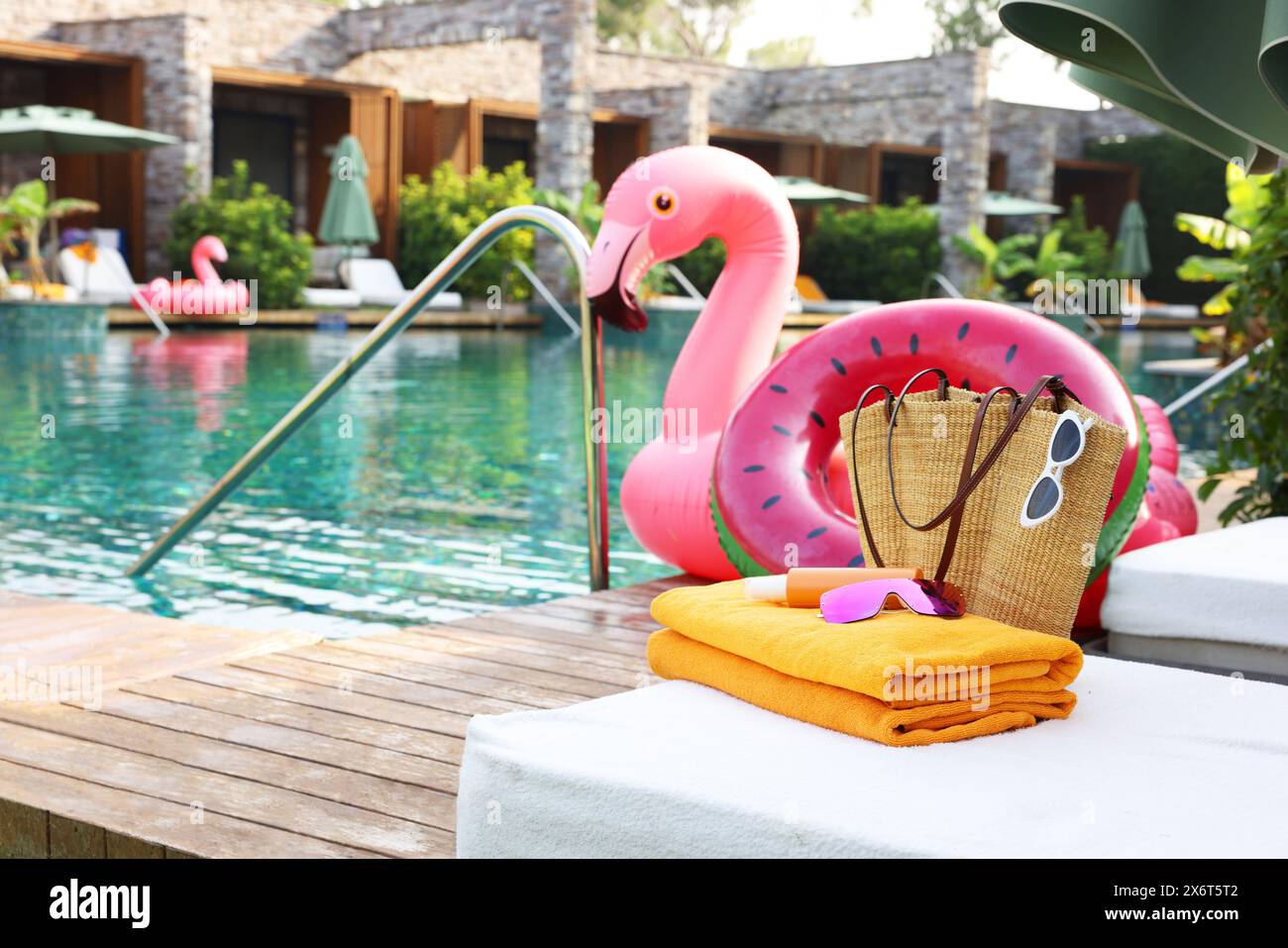 Beach accessories on sun lounger, inflatable ring and float near ...
