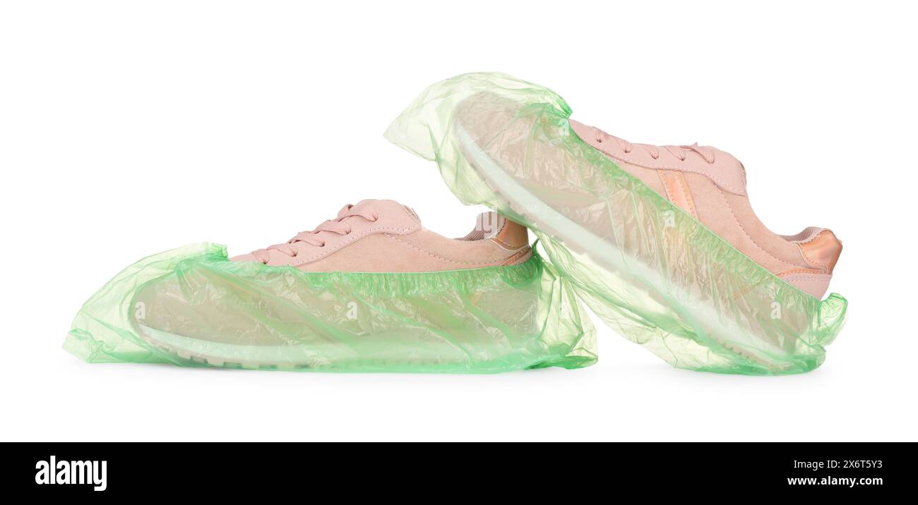 Sneakers in green shoe covers isolated on white Stock Photo - Alamy
