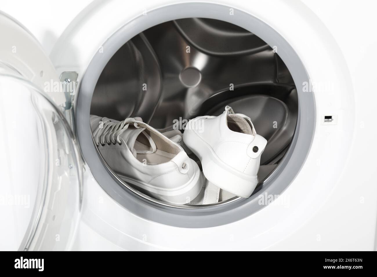 Stylish clean sneakers inside modern washing machine Stock Photo - Alamy