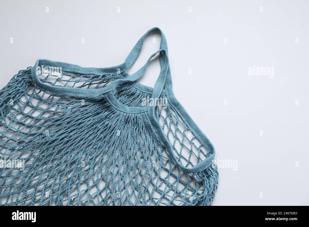 Blue string bag on light grey background, top view Stock Photo - Alamy