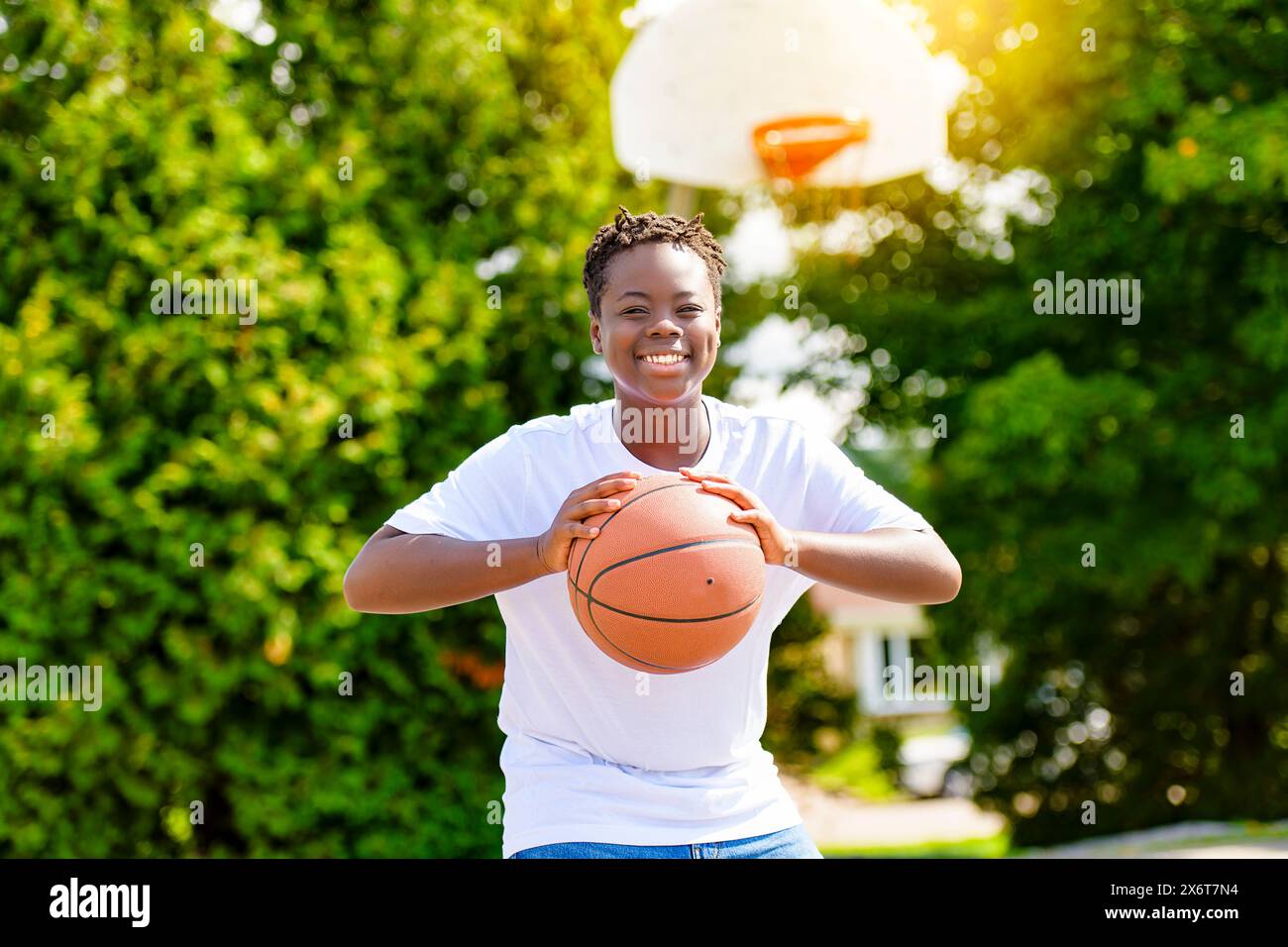 Portrait of american basketball player guy standing at basketball court ...