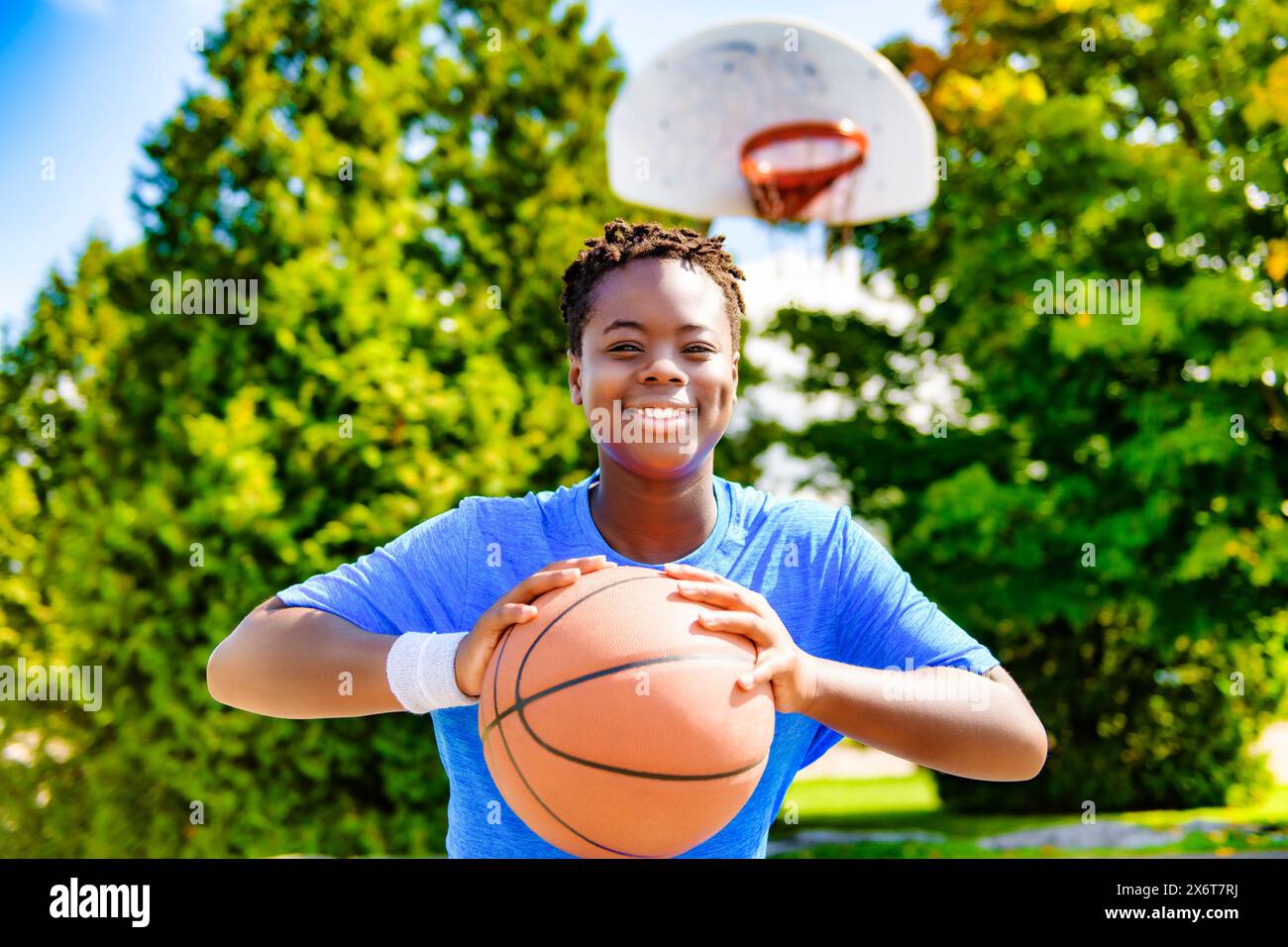Portrait of american basketball player guy standing at basketball court ...
