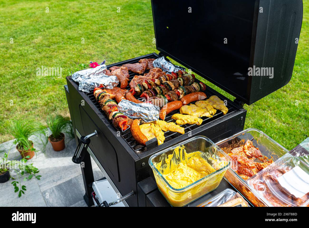 A modern rectangular grill standing on a paving slab on a garden ...