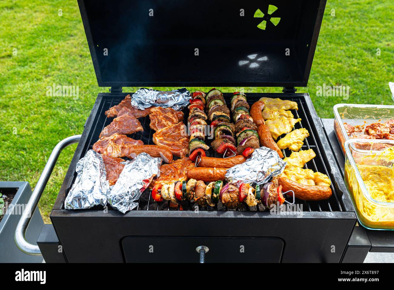 A modern rectangular grill standing on a paving slab on a garden ...
